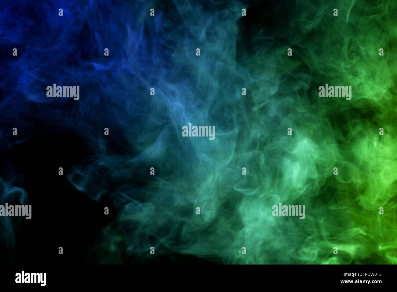 Colorful blue and green smoke on a black isolated background ...