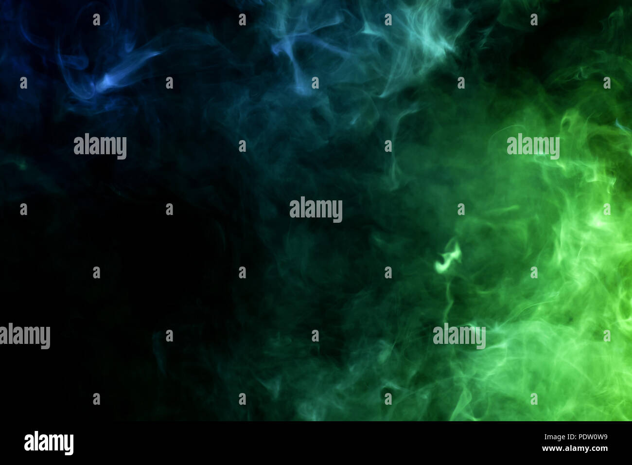 Colorful blue and green smoke on a black isolated background ...