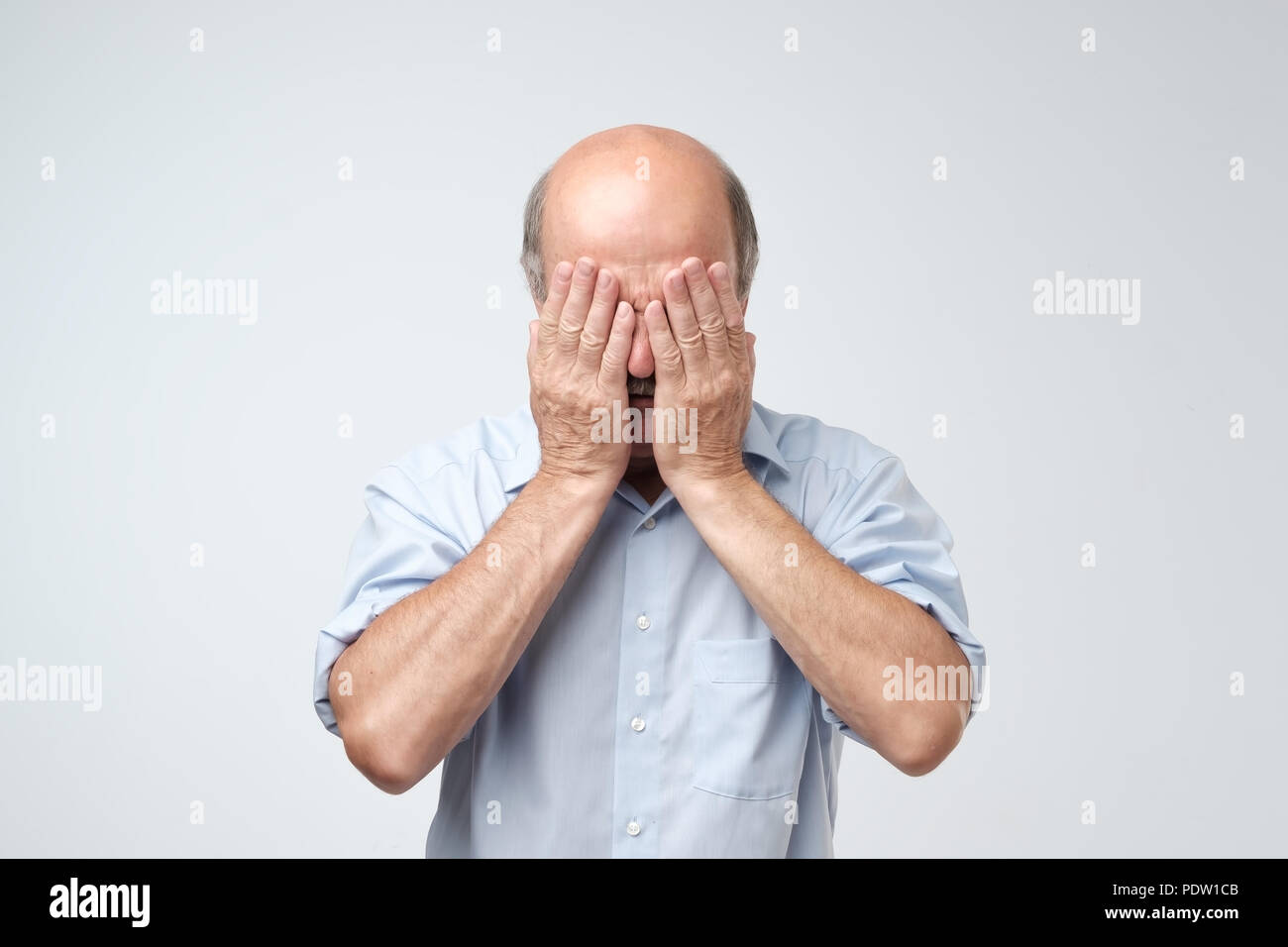 Depressed man hands over face hi-res stock photography and images - Alamy