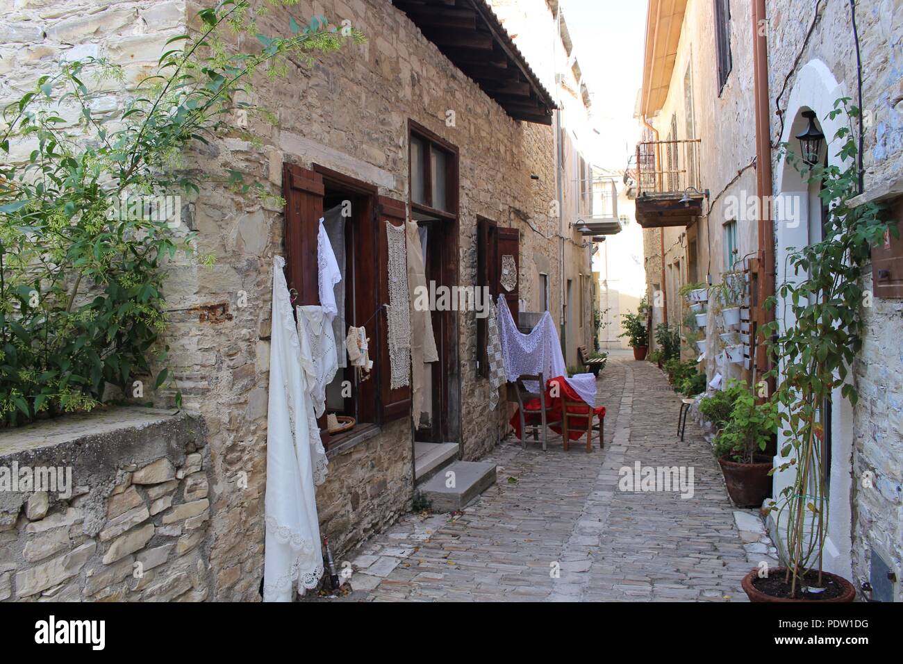 Narrow street in Larnaca. Narrow walking road between traditional stone ...