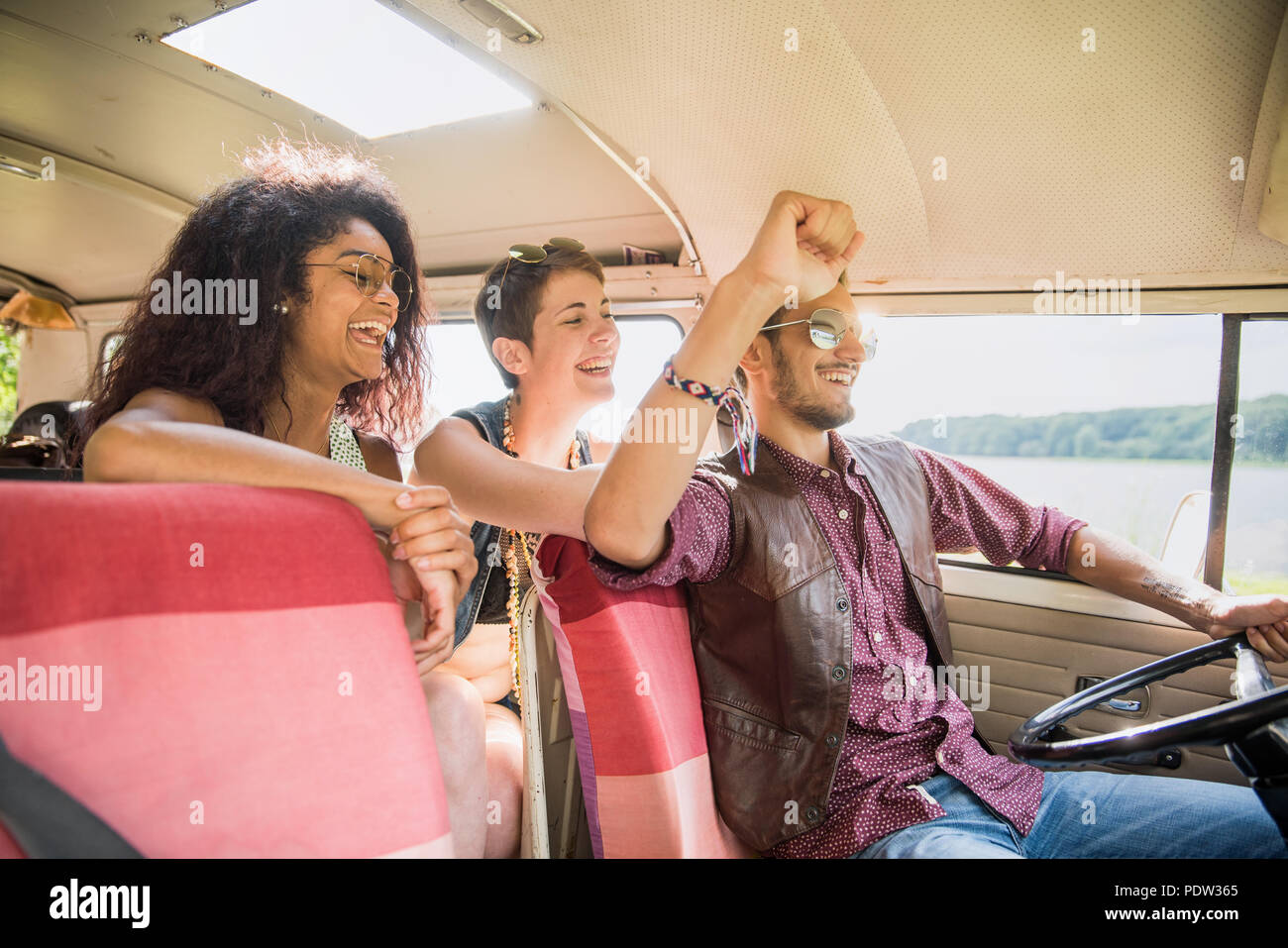 Young woman driving camper van smiling hi-res stock photography and ...