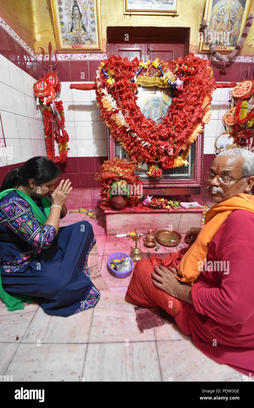 A hindu lady performs Kali puja with the help of pujari at the ...