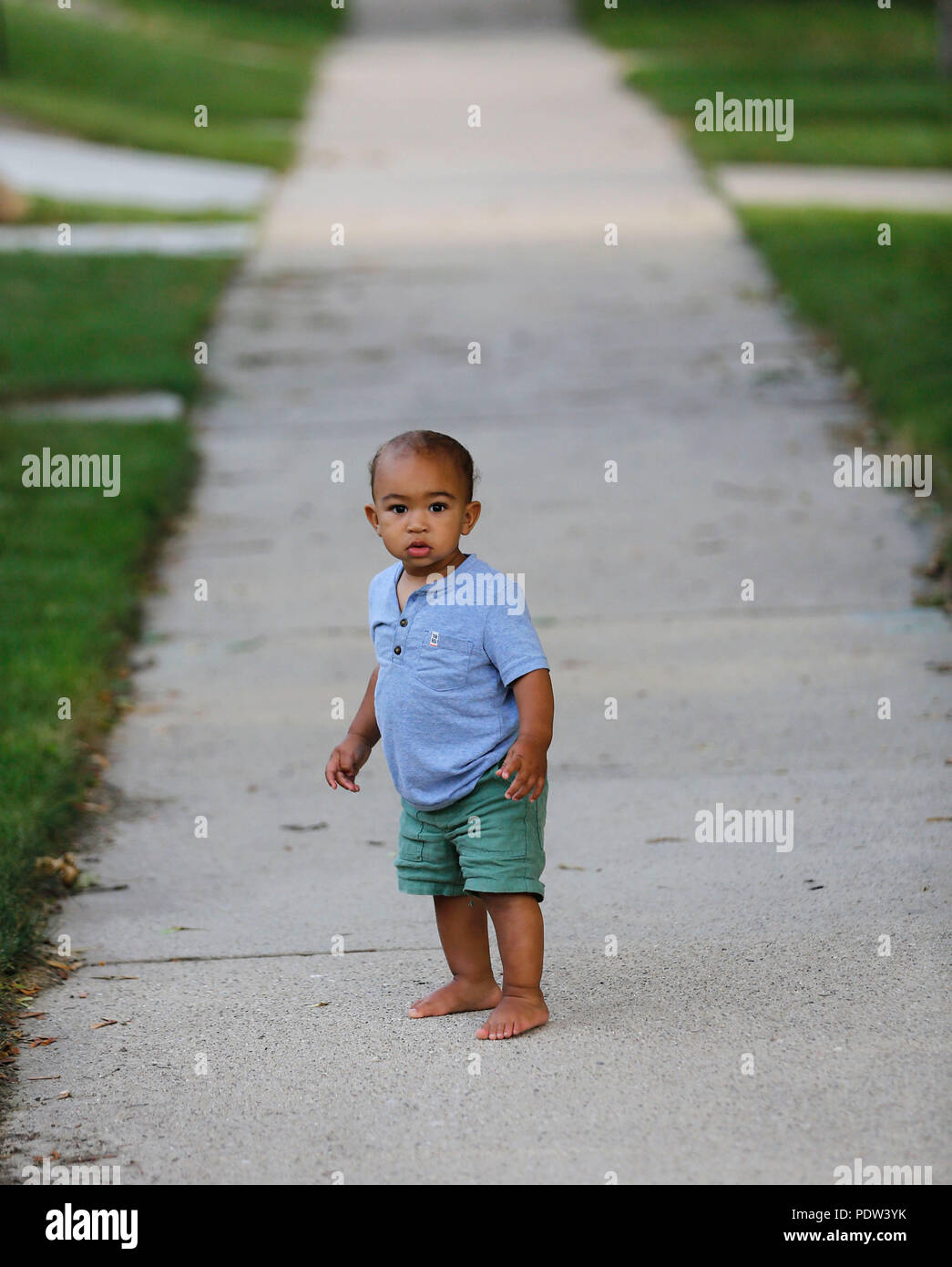 Toddler boy navigates a sidewalk Stock Photo - Alamy