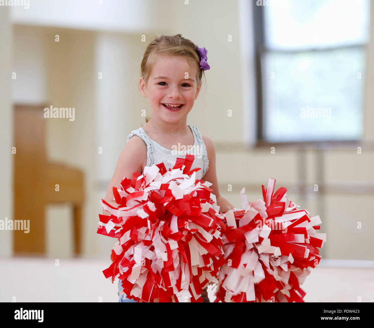 A Four Year Old Girl Participates In A Cheerleading Class Stock Photo a-four-year-old-girl-participates-in-a-cheerleading-class-stock-photo