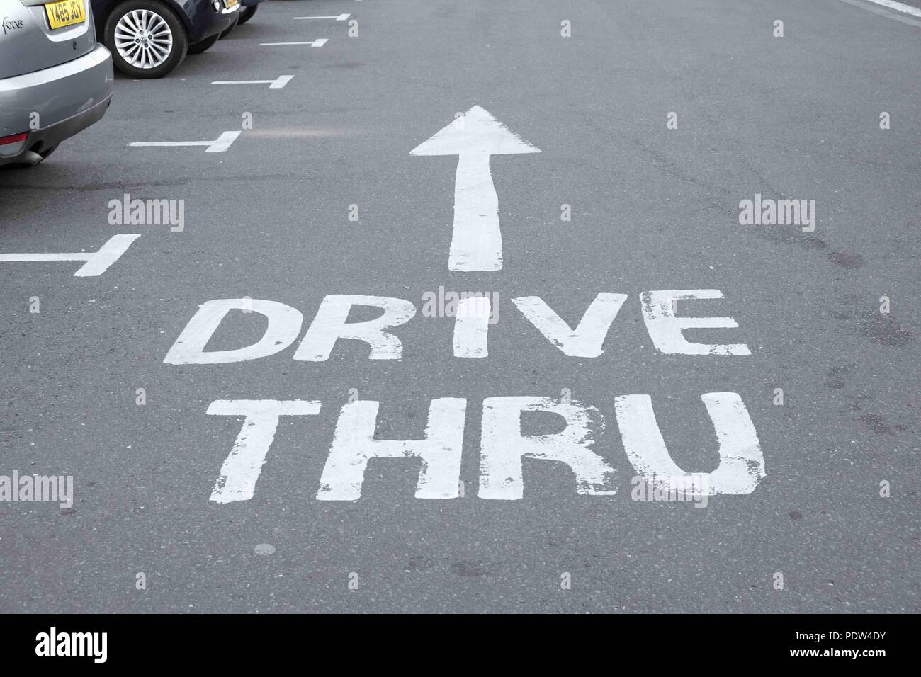 Drive Thru painted sign on car park surface Stock Photo - Alamy