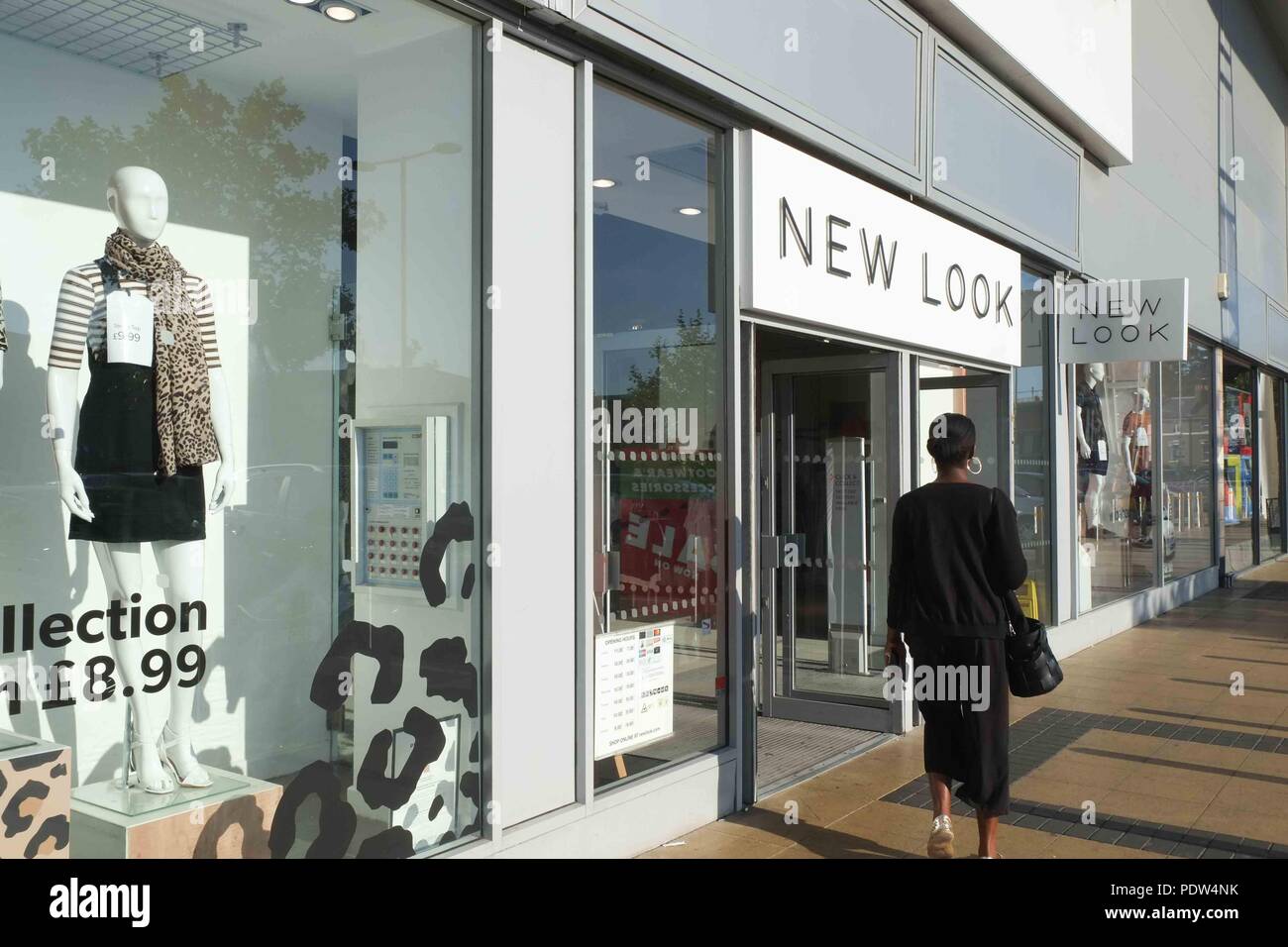 A woman walks past a New Look store in a London High Street Stock Photo ...