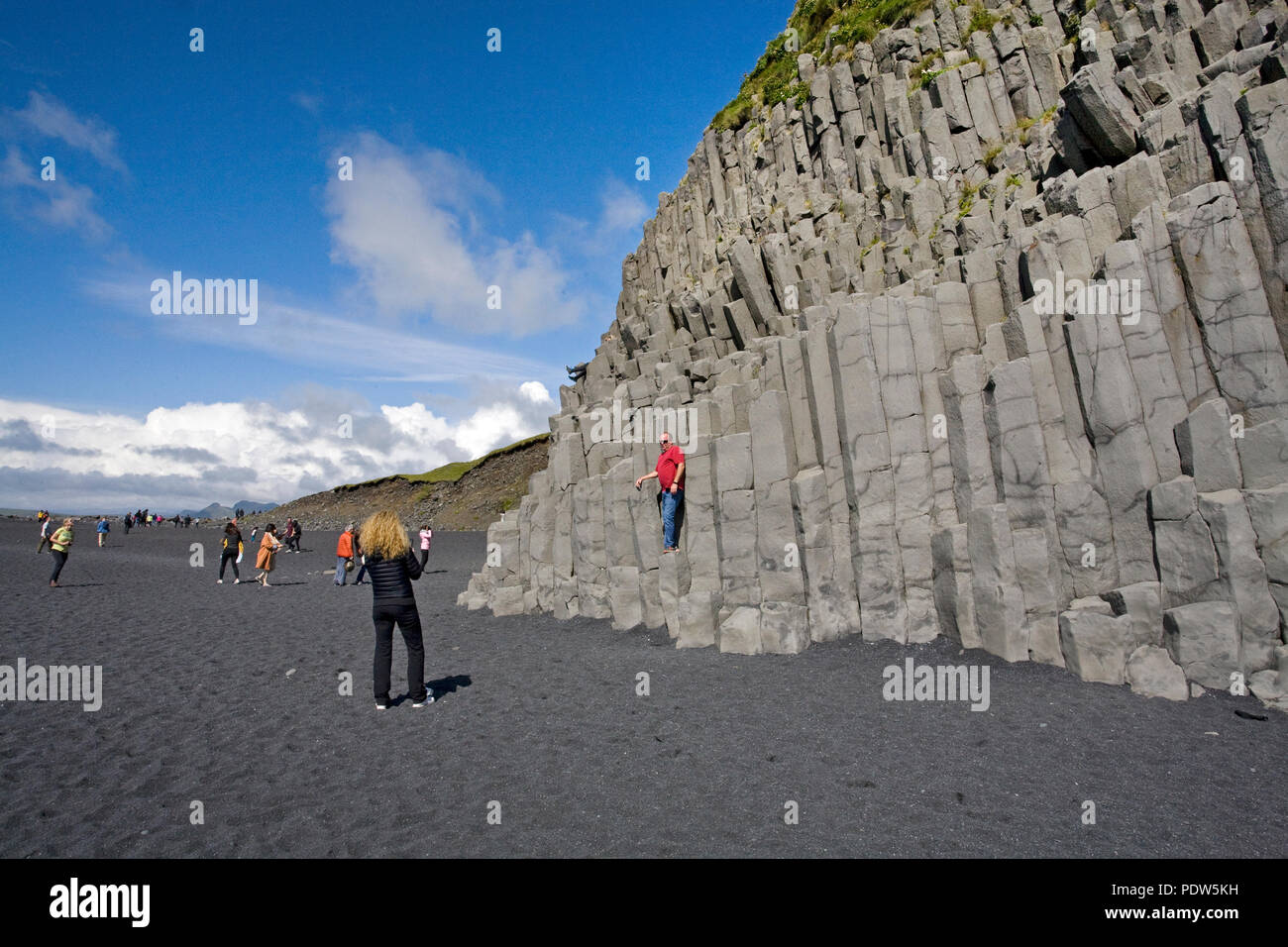 A mountain of columnar basalt known as the Reynisdrangar, on a black ...