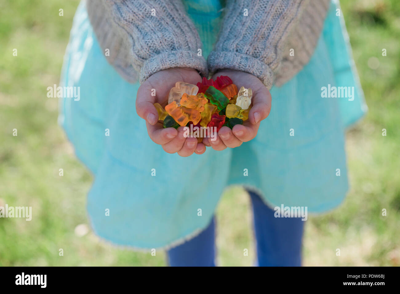 Child holding candy Stock Photo - Alamy