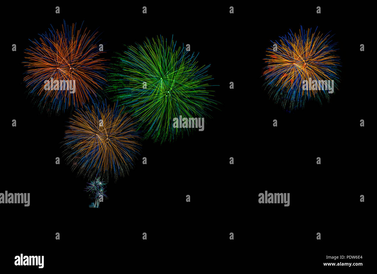 colorful flashes of night fireworks over the ocean with floating yachts ...