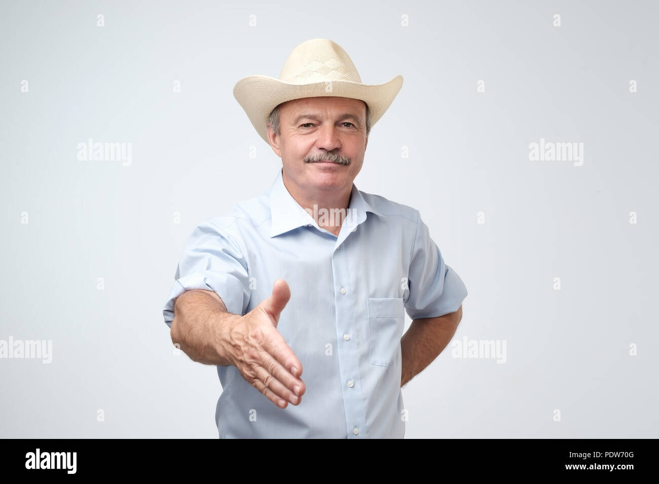 You are welcome concept. Cheerful mature man in blue shirt and cowboy ...