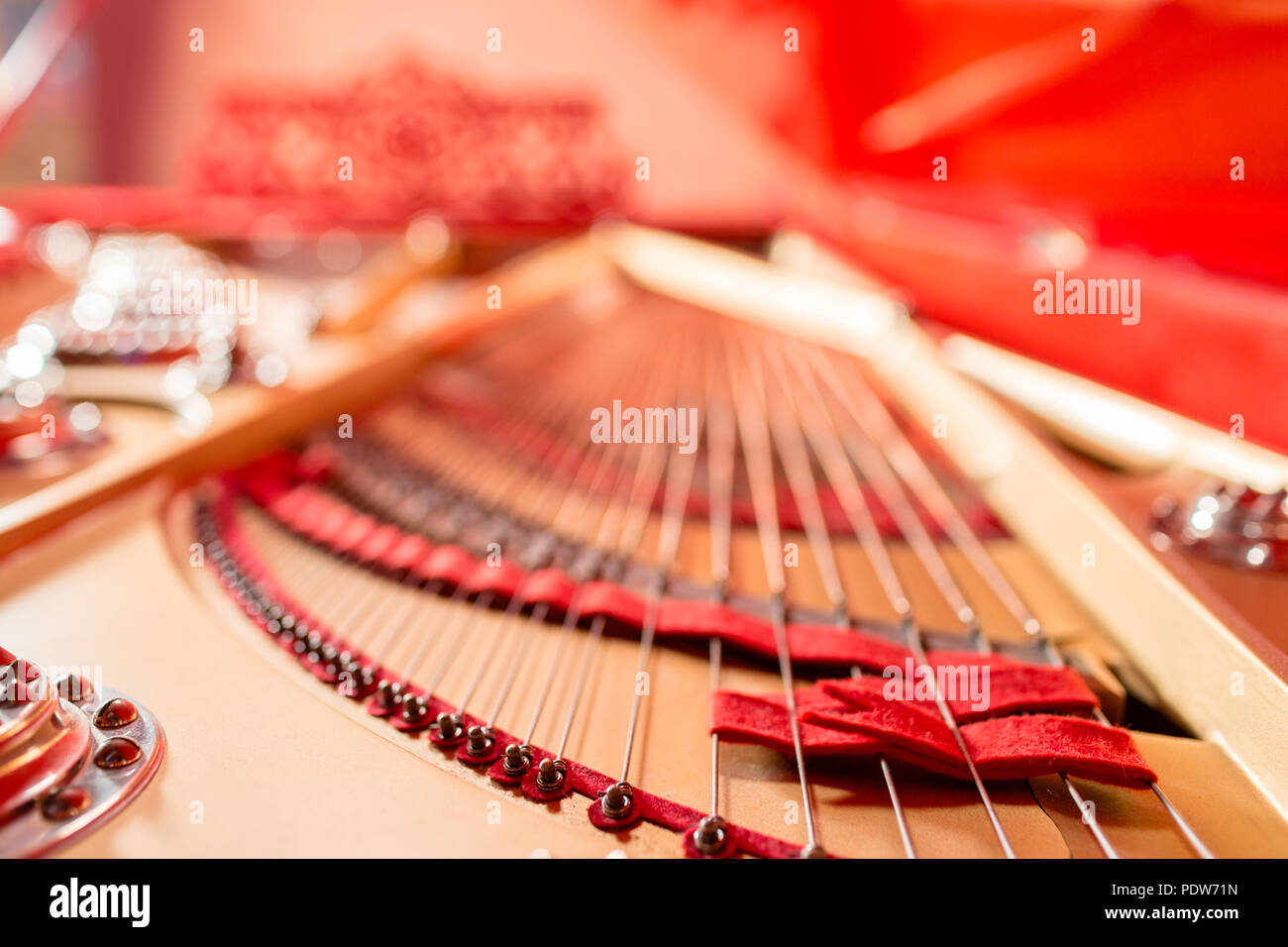 Strings inside a red grand piano. Piano playing, dampers, felt hammers ...
