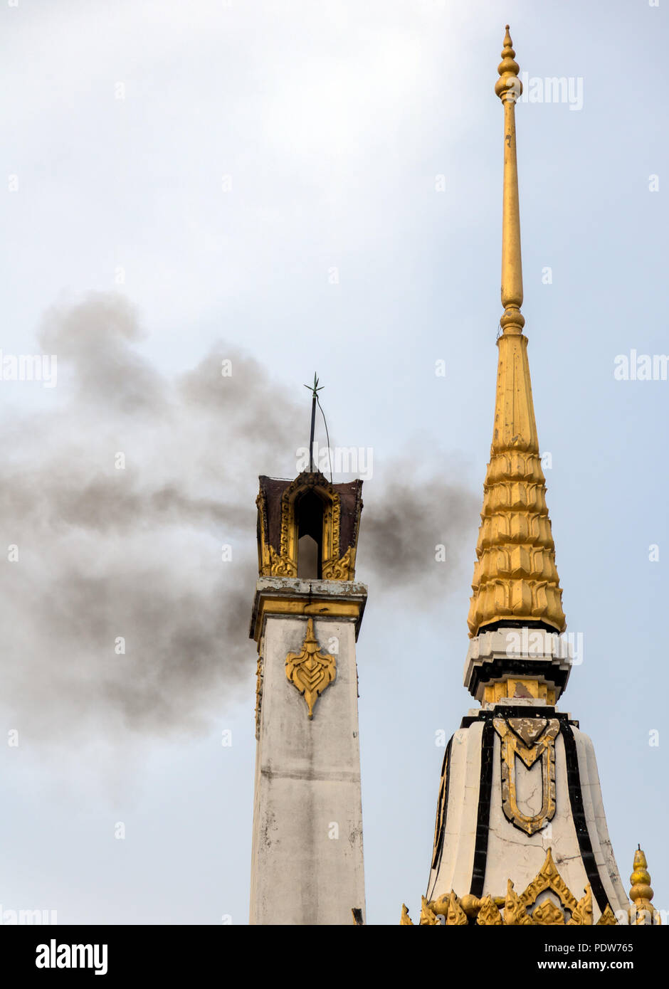 Smoke rises from a chimney crematorium in a Buddhist monastery ...