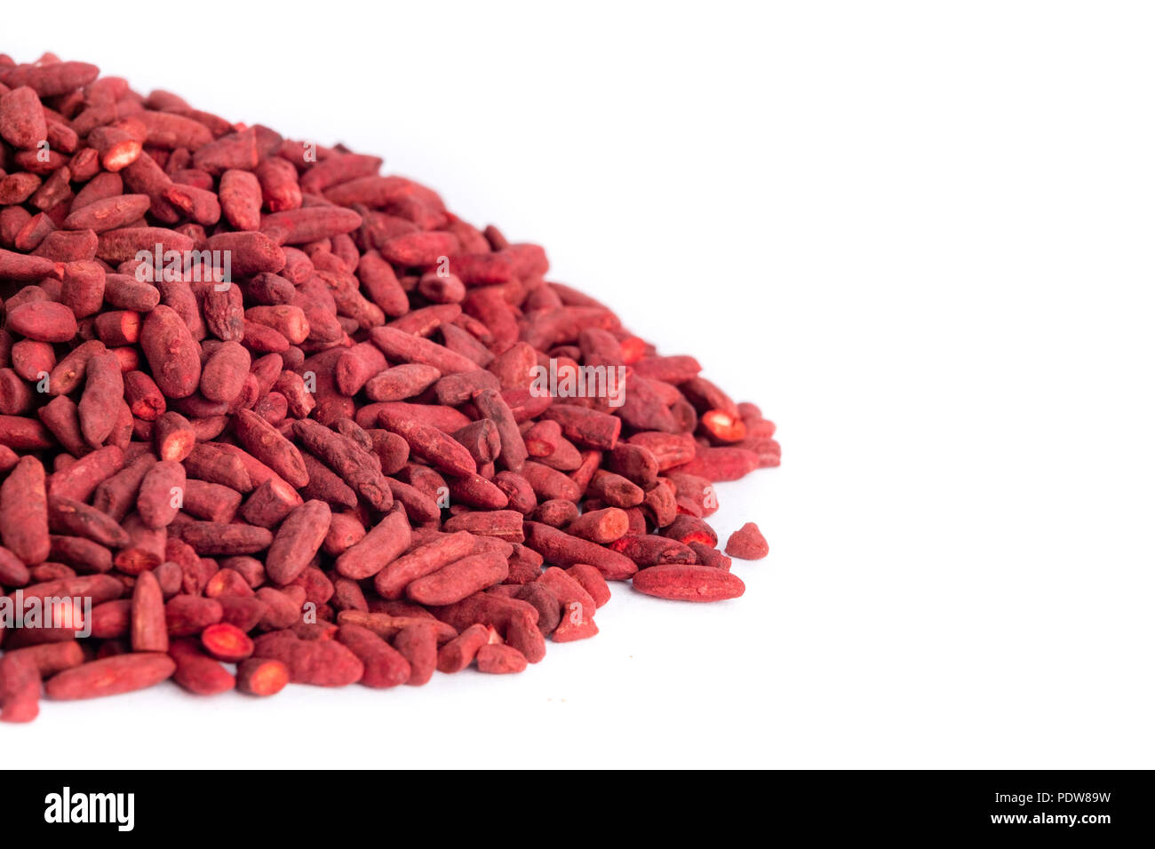 Red yeast fermented rice on white background Stock Photo - Alamy