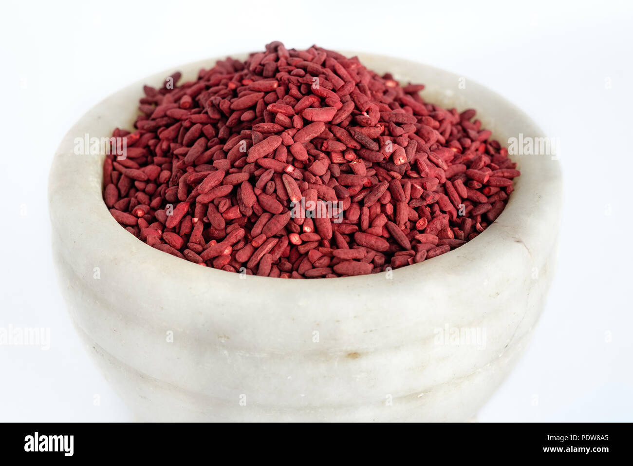 Red yeast fermented rice on white background Stock Photo - Alamy