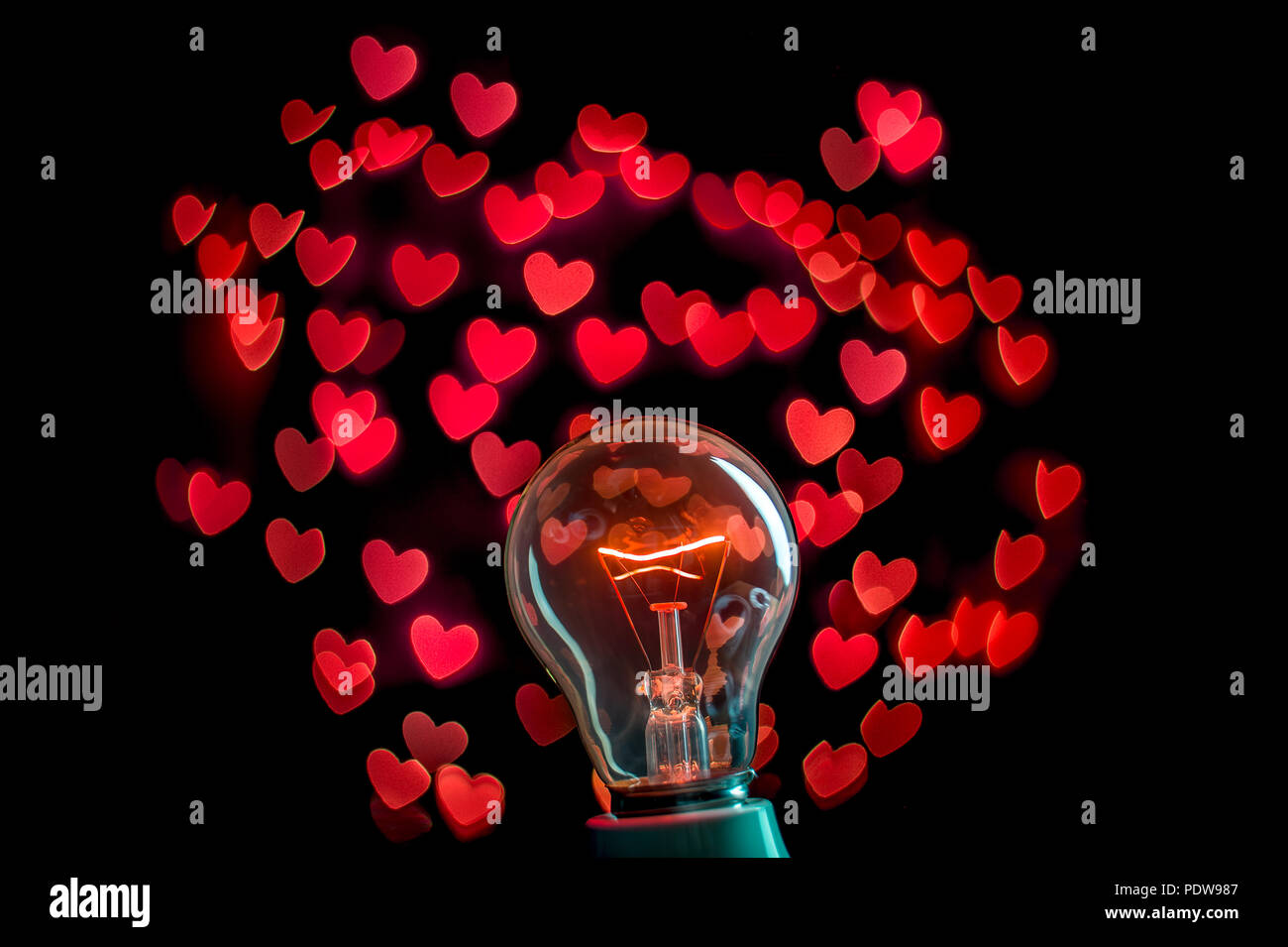 Lighting bulb with beautiful red heart bokeh background Stock Photo - Alamy