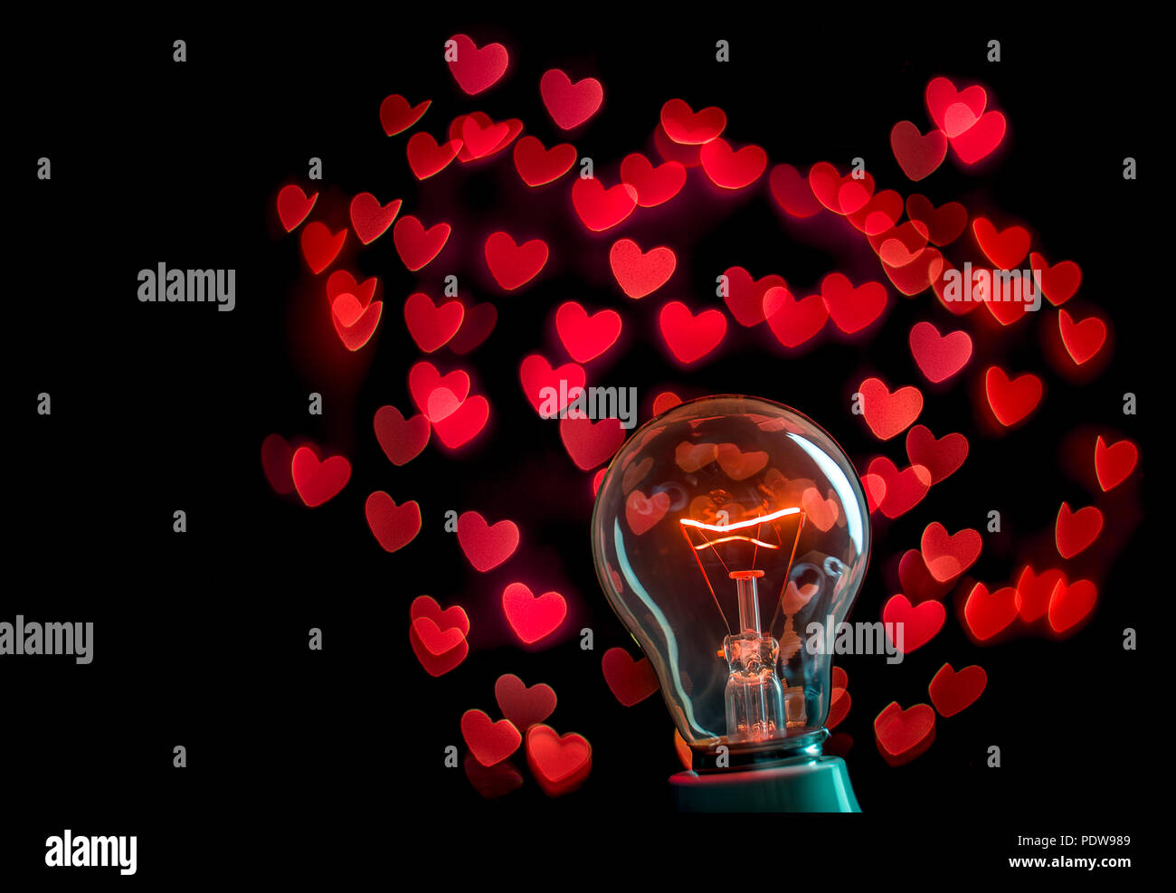 Lighting bulb with beautiful red heart bokeh background Stock Photo - Alamy