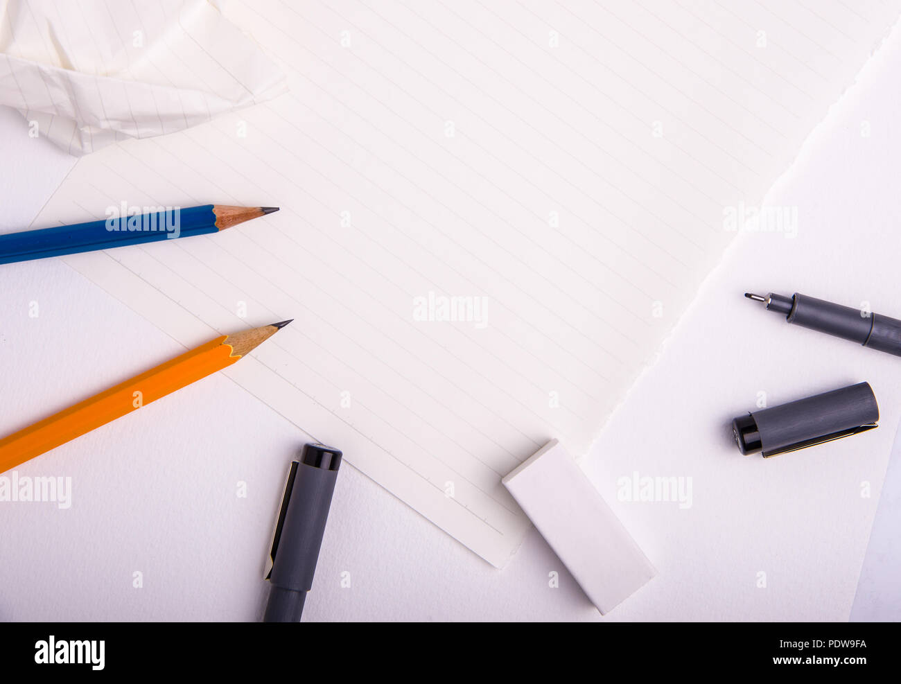 Top view of office stationary with pens, pencils and rubber on white ...