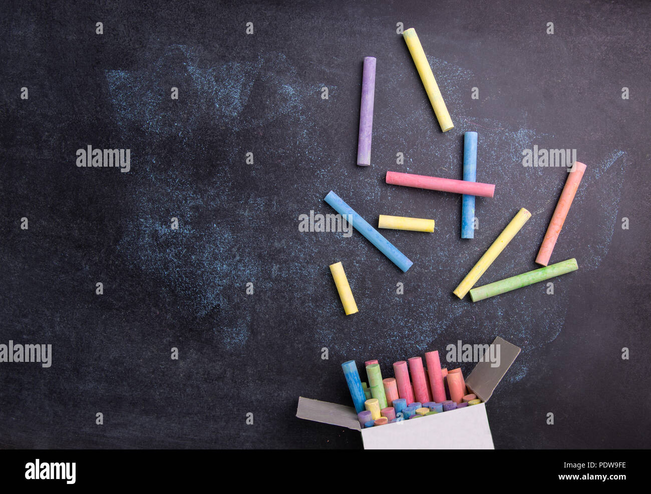Top view of colorful chalk on blackboard background Stock Photo - Alamy