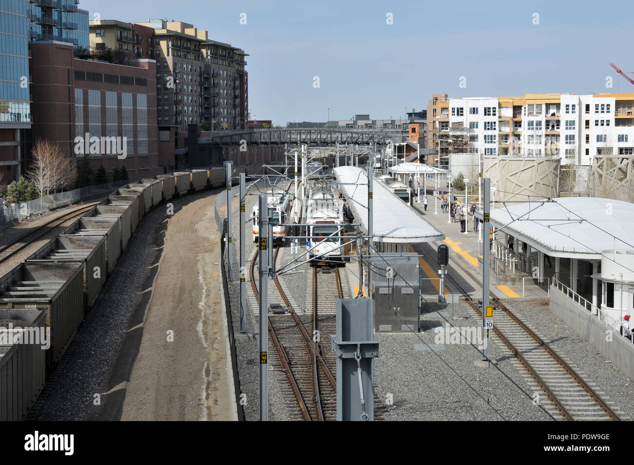 A freight train and the Union Station Light Rail stop at the new ...