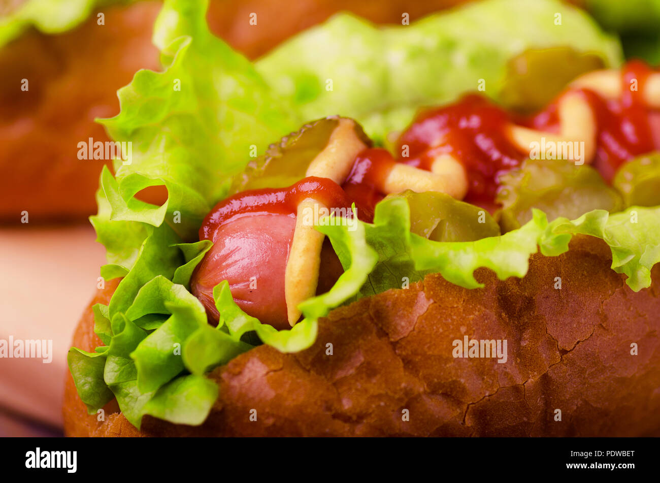 Hot dog with mustard and ketchup, close-up on a wooden background Stock ...