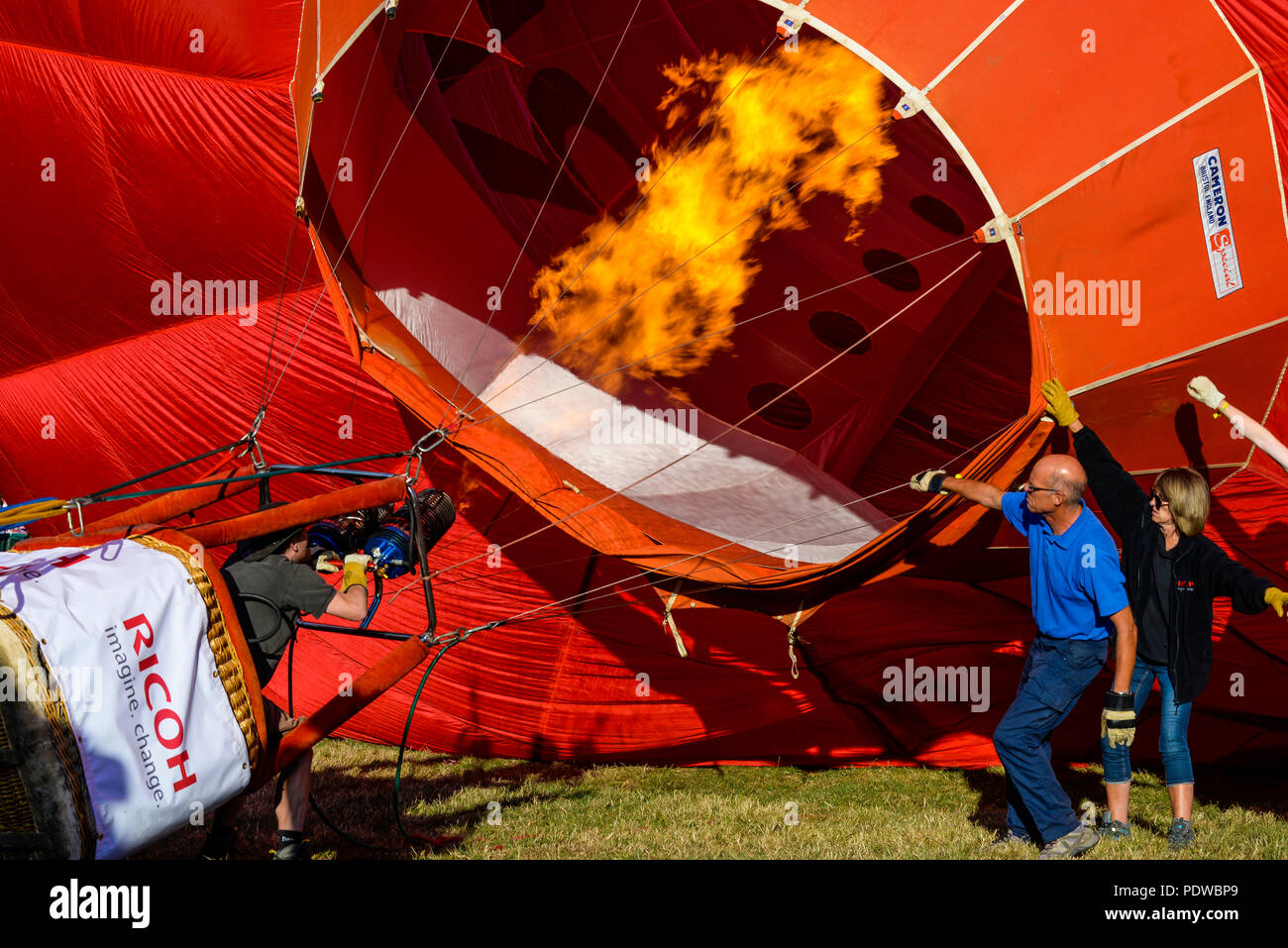 Gas burner of hot air balloon burning to inflate balloon envelope ...