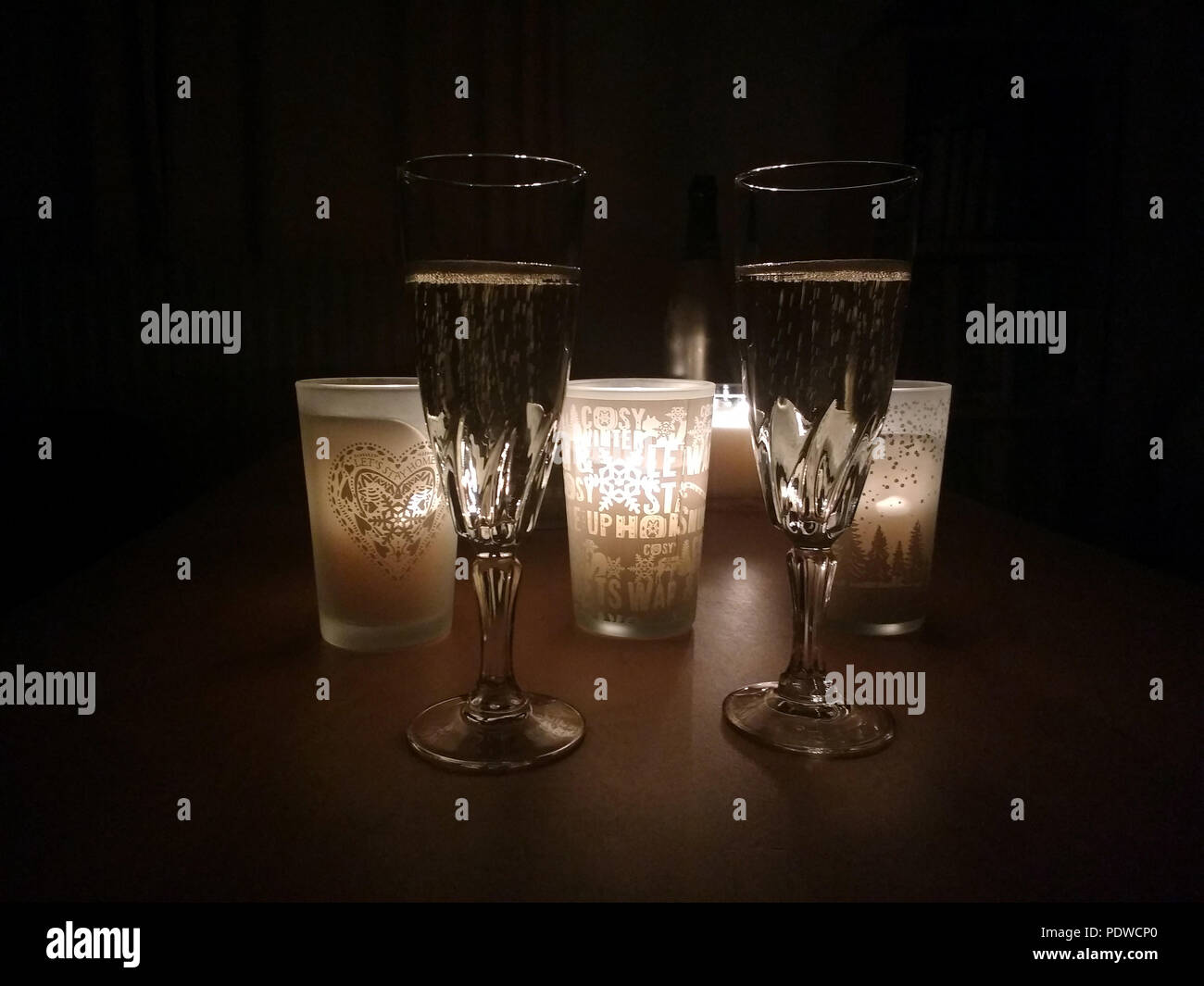 Champagne glass lit by candle light Stock Photo - Alamy