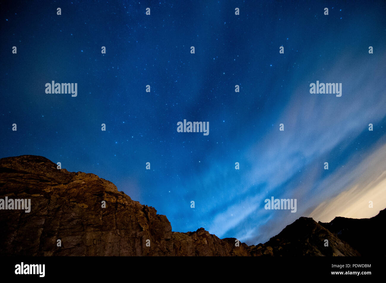 night view with stars and blue sky over the mountains Stock Photo - Alamy