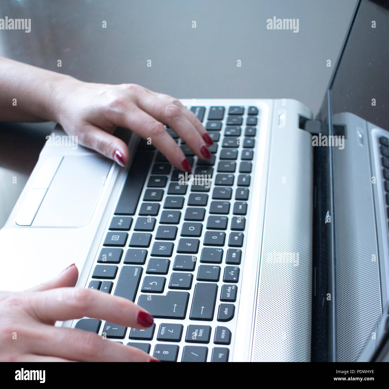 Secretary typist typing on laptop pc computer keyboard keys with hands ...