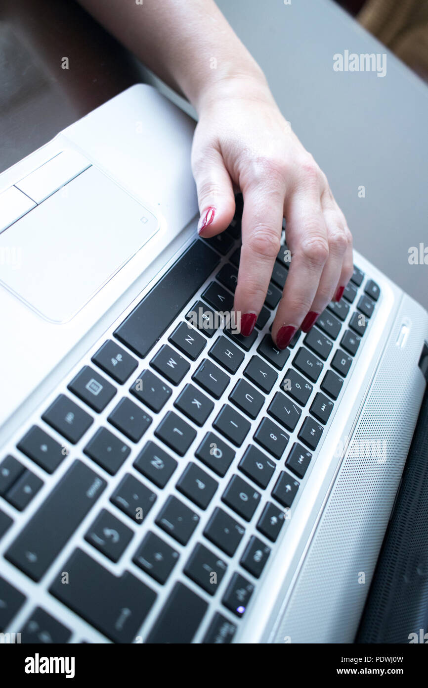 Secretary typist typing on laptop pc computer keyboard keys with hands ...