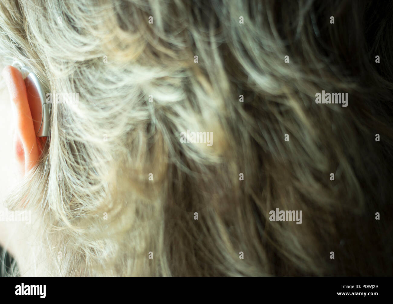 Deaf lady with modern technology digital hearing aid in her ear Stock ...