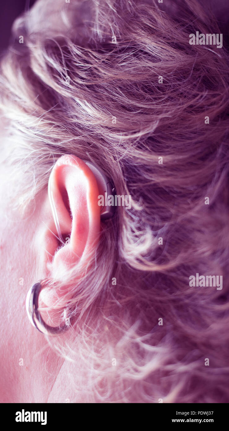 Deaf lady with modern technology digital hearing aid in her ear Stock ...
