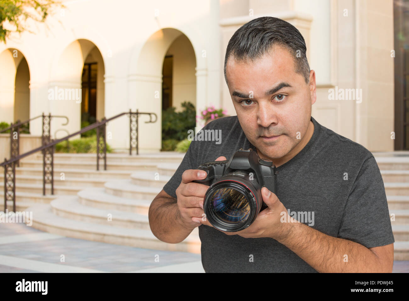 Hispanic Young Male Photographer With DSLR Camera Outdoors Stock Photo ...