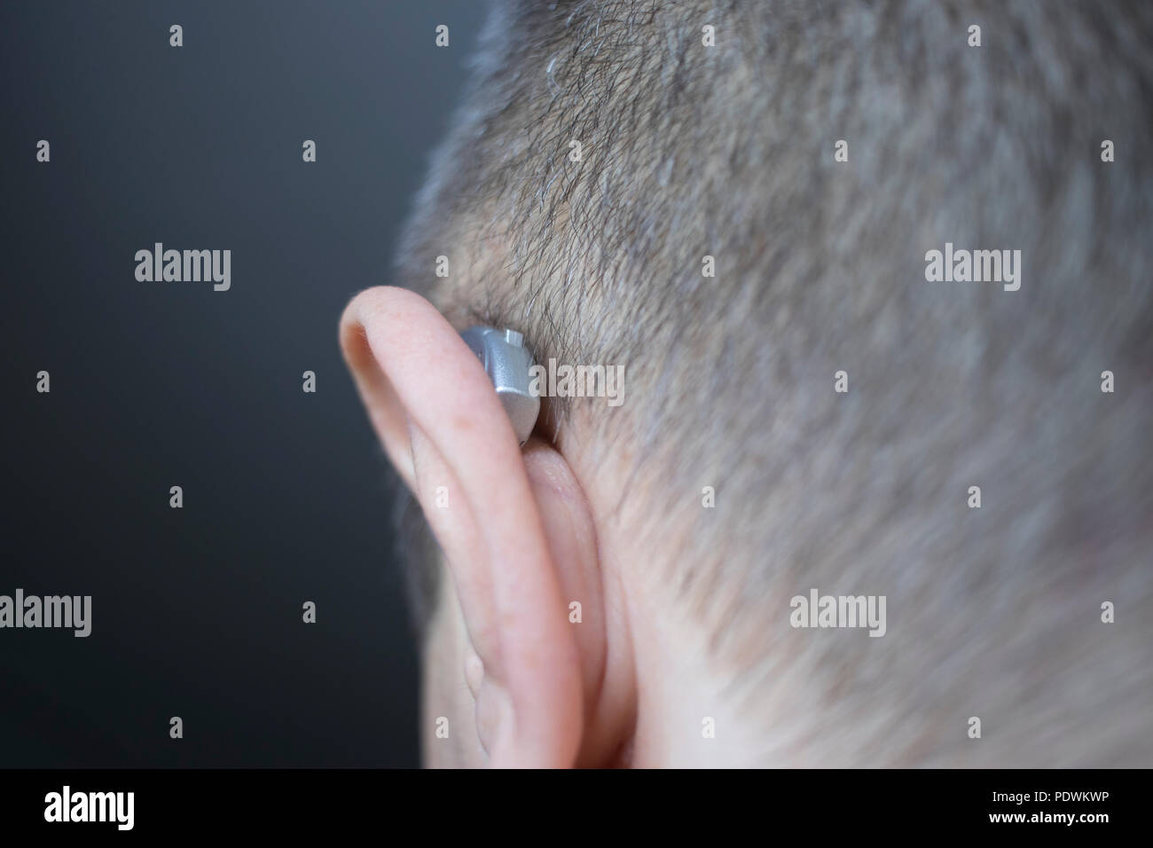 Modern compact in the ear digital audiophone hearing aid in the ear of ...