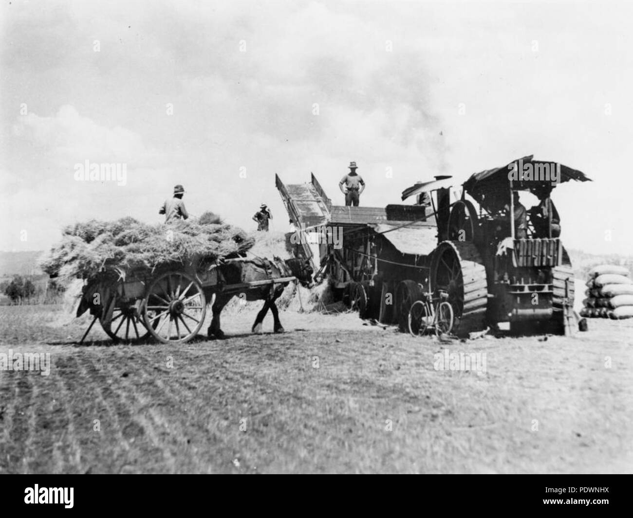 Vintage agricultural threshing machine Black and White Stock Photos ...