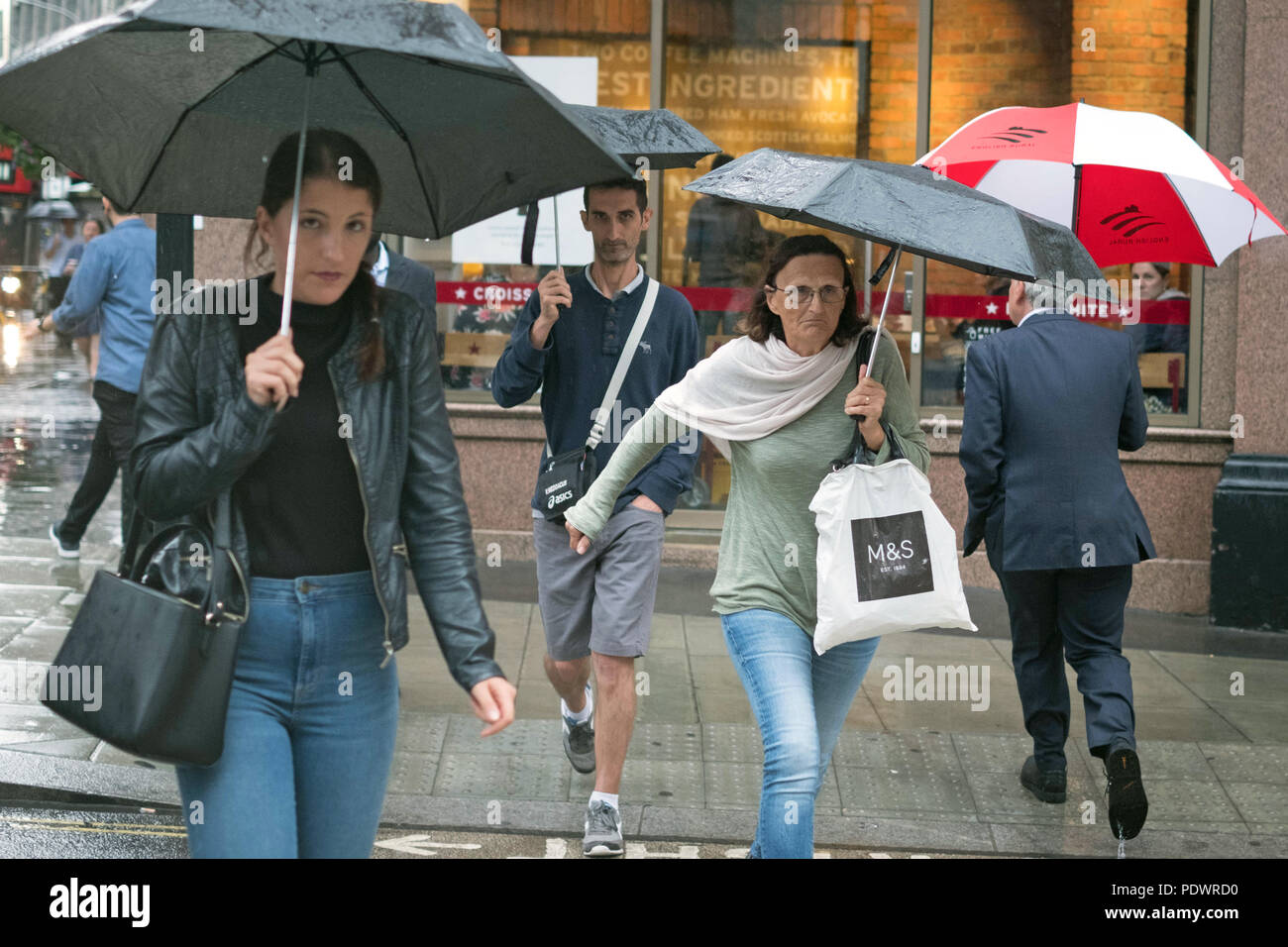 Shoppers get caught in heavy rain on londons victoria street hi-res ...