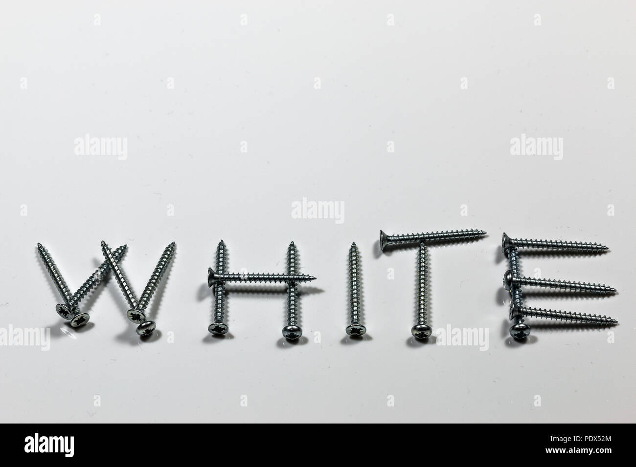 The word WHITE written with screws on white background Stock Photo - Alamy