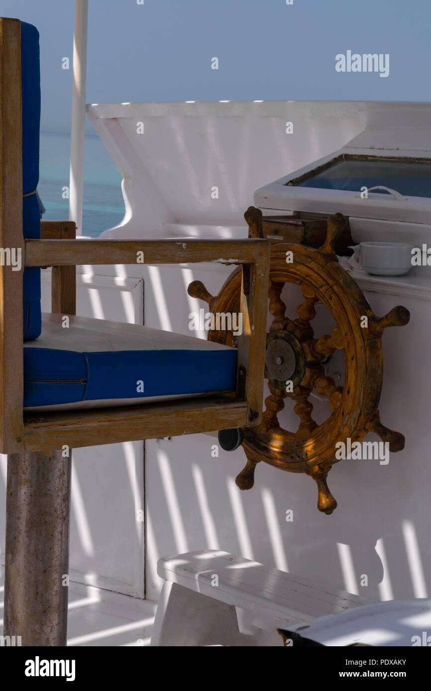 wooden old ship helm in red sea, travelling in white yacht Stock Photo ...
