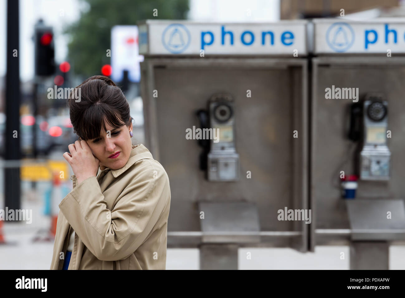 Female film extra dressed in 1960s style in front of vintage American ...