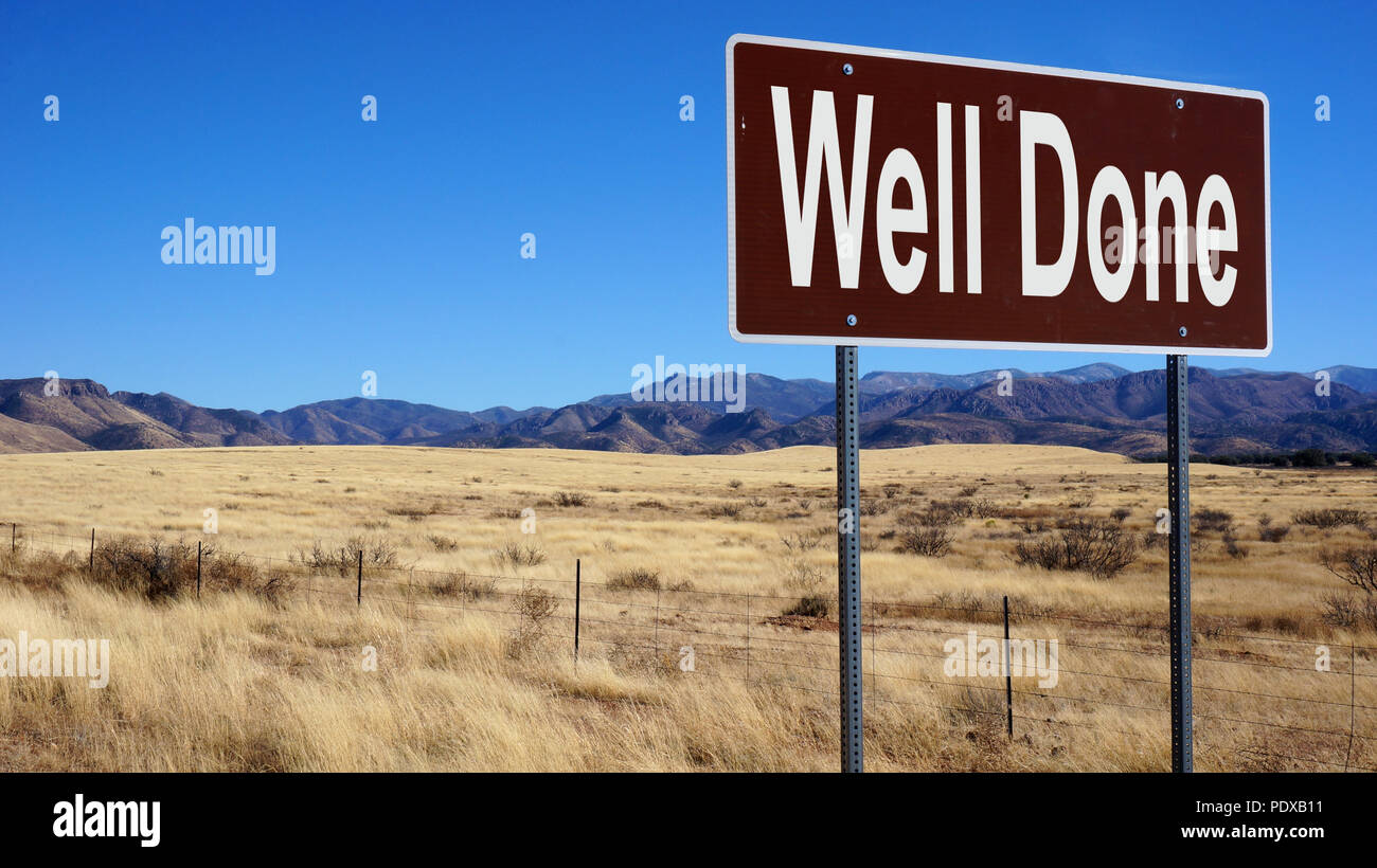 Well Done road sign with blue sky and wilderness Stock Photo - Alamy