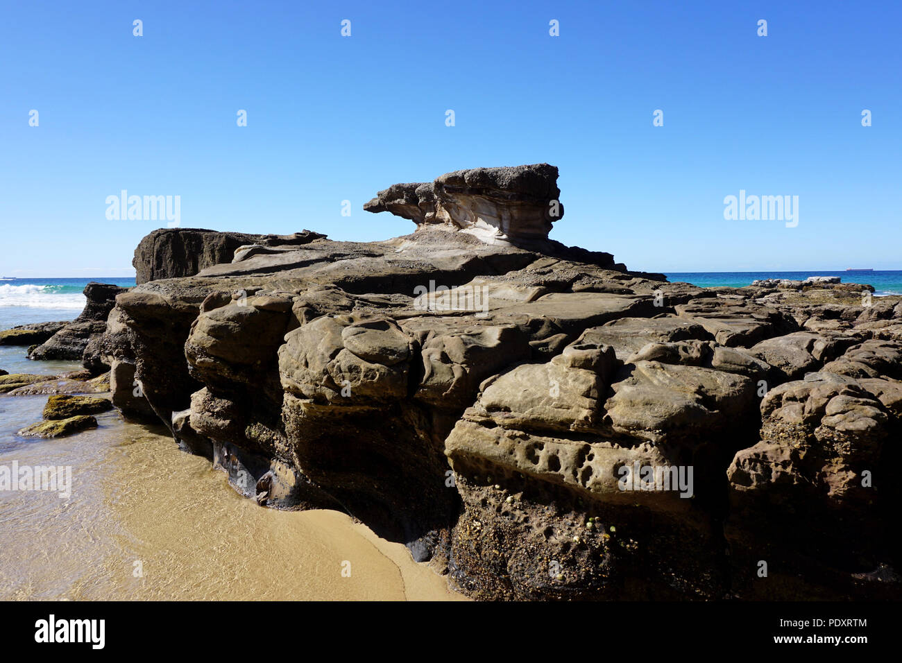 Coastal Rock Formation with an Outcrop in the Shape of a Wave at Caves ...