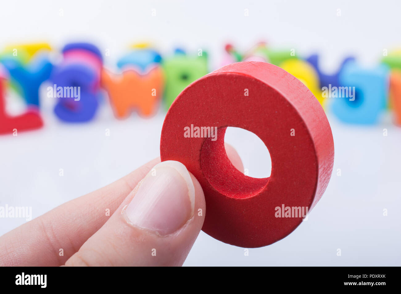 Hand holding letter cube O of made of wood Stock Photo - Alamy