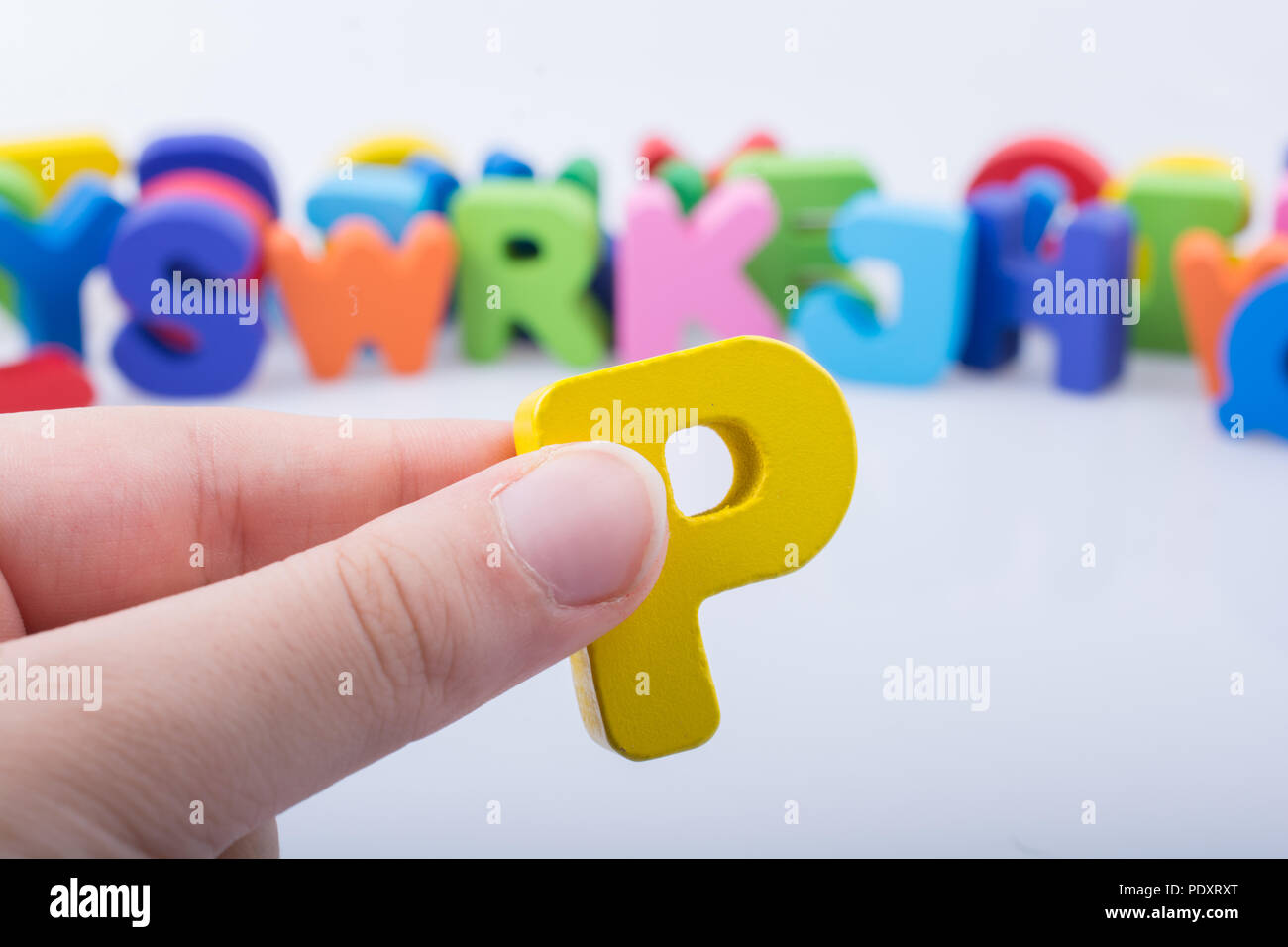 Hand holding letter cube P of made of wood Stock Photo - Alamy