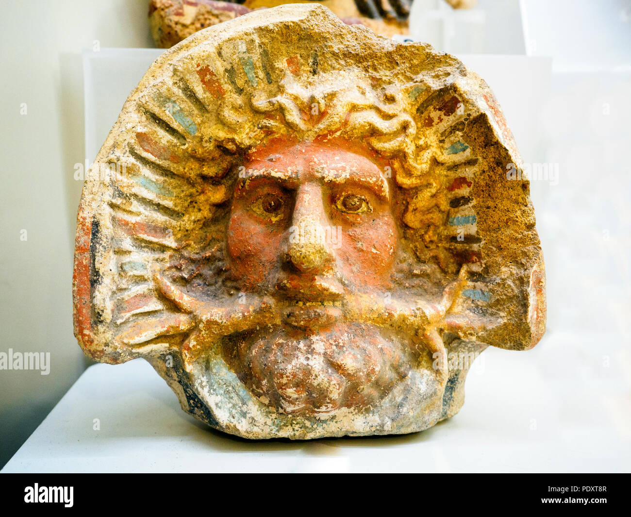 Antefix with a head of deity that tightens a thunderbolt between the ...