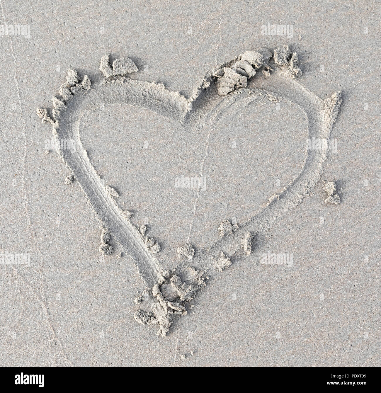 Heart drawn in the wet sand. Beach background. Top view Stock Photo - Alamy