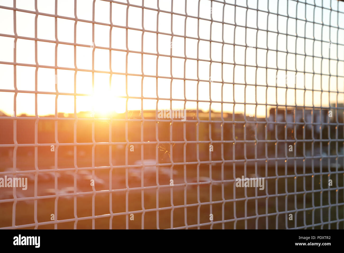The sunlight shines through the fence Stock Photo - Alamy