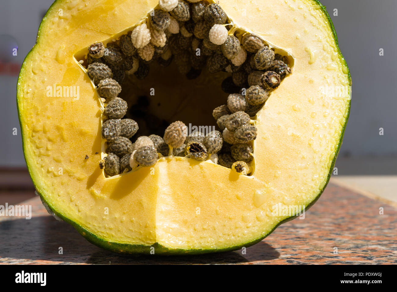 raw delicious halved papaya fruit with star of pit Stock Photo - Alamy