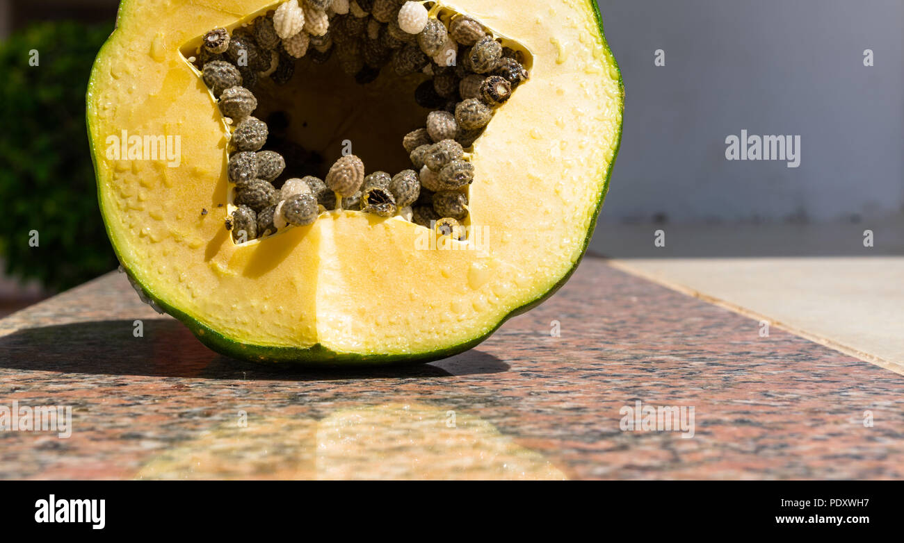 raw delicious halved papaya fruit with star of pit Stock Photo - Alamy