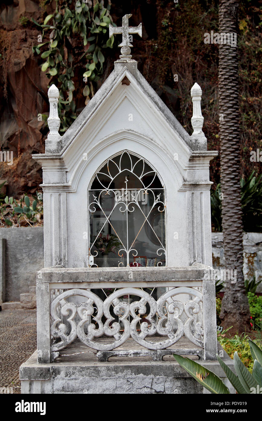 Little white and decorative tomb at a graveyard of Madeira, Portugal ...