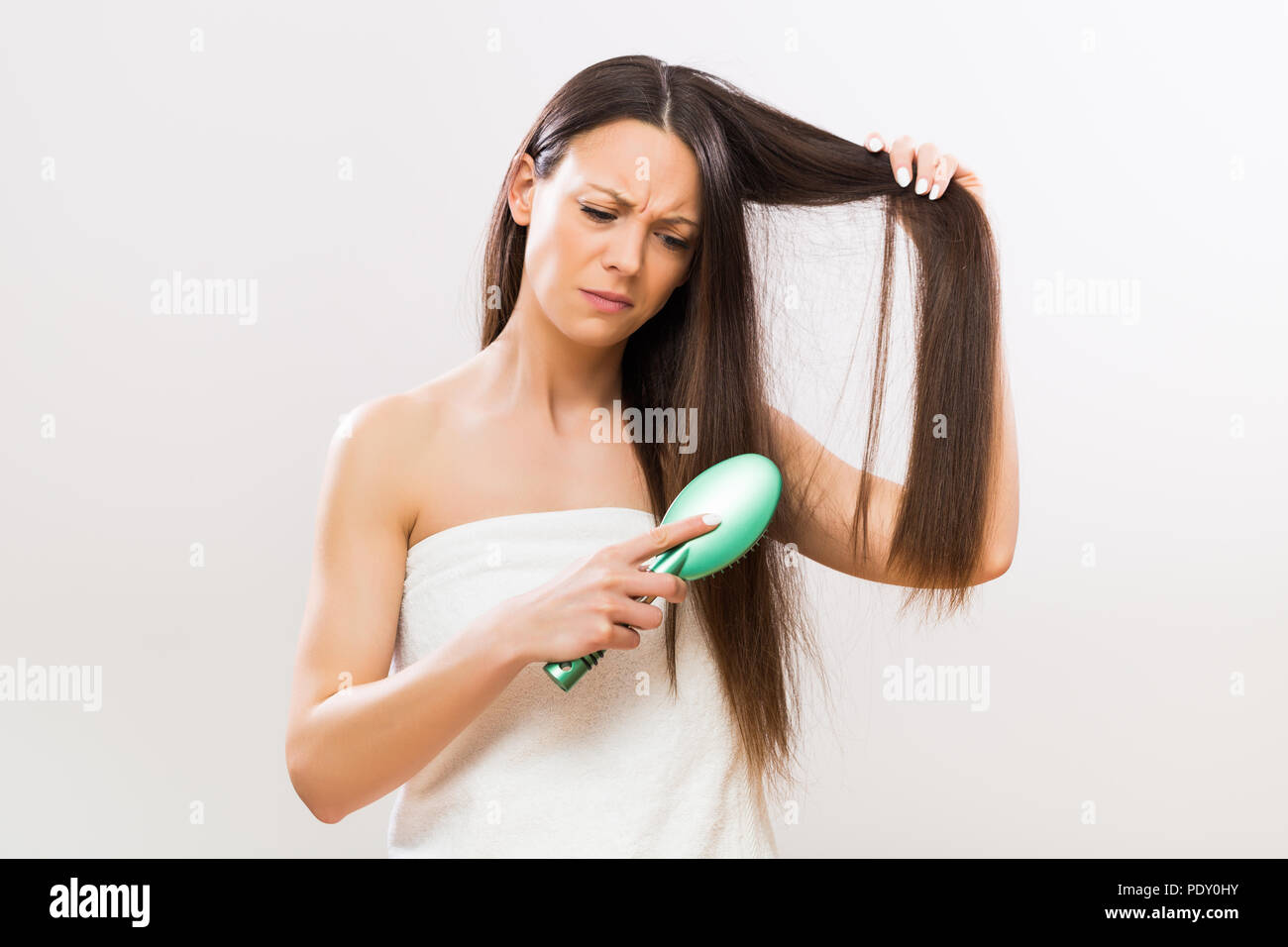 Image of angry woman brushing her hair on gray background Stock Photo ...