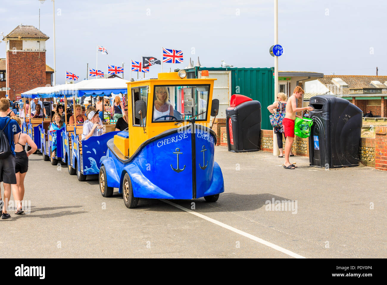 Small yellow and blue road train on East Beach promenade at ...